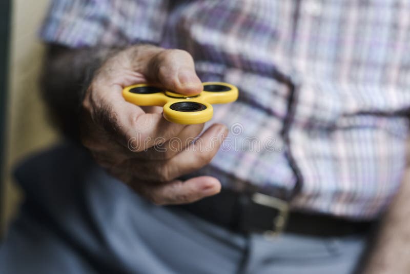 Old Man Playing with a Fidget Spinner Stock Photo - Image of play ...