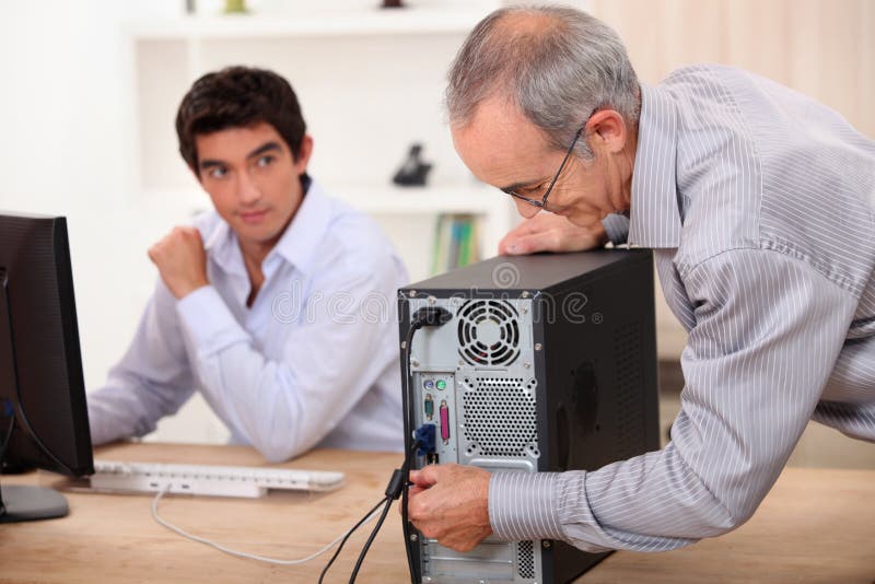 Old man plugs a computer stock photo. Image of group - 37039488