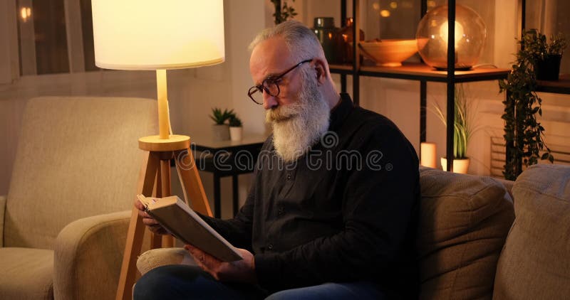 Old Man Reading a Book Late Night Stock Video - Video of house, living ...
