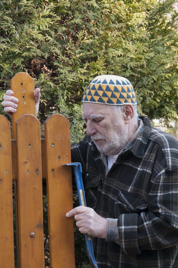 Old man repairing a gate stock image. Image of grandfather - 30924957