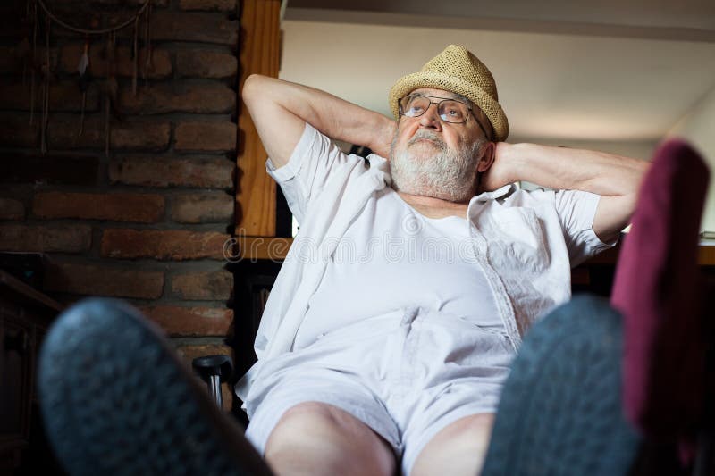 Old man resting in a chair stock image. Image of retired - 74172949