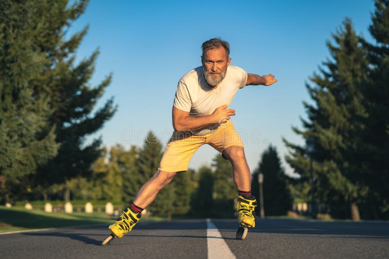 The Old Man Rollerblading on the Asphalt Stock Photo - Image of ...