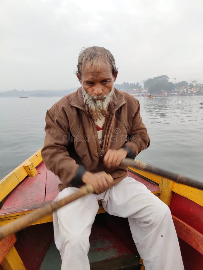 Old Man rowing a boat editorial stock image. Image of green - 173140069