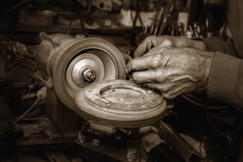 Old Man`s Hands with Tool and Grinding Machine with Diamond Whe Stock ...