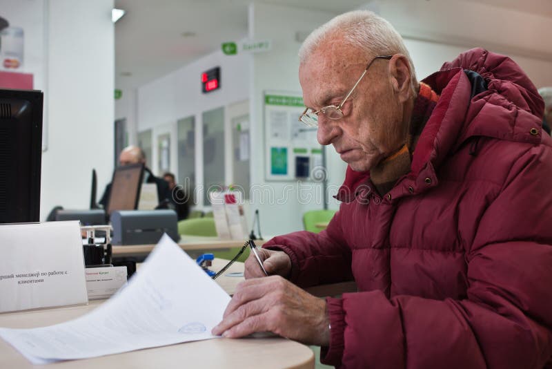 Old Man is Signing Documents at Bank Stock Photo - Image of looking ...