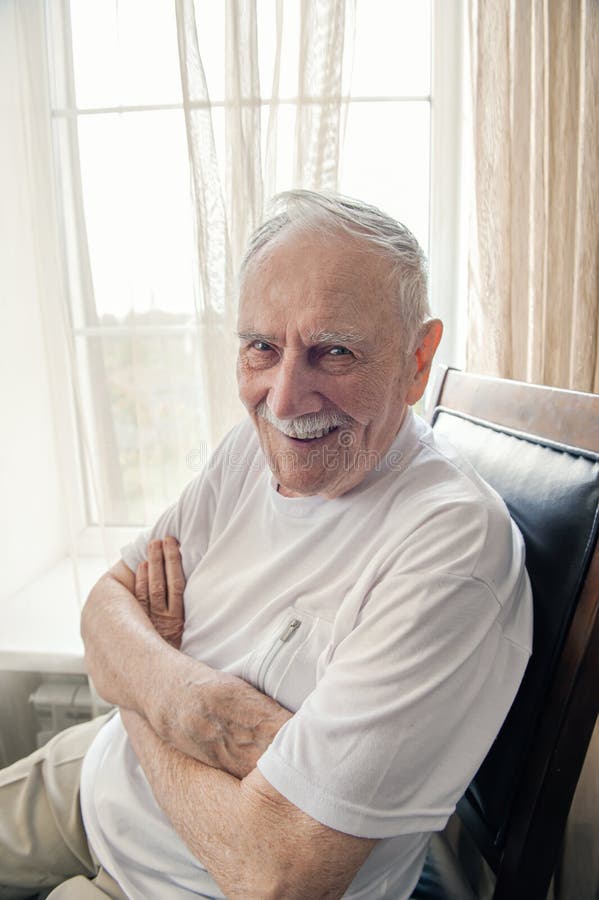 Old Man is Sitting in a Chair. Smiling Old Man Sitting in a Chair by ...