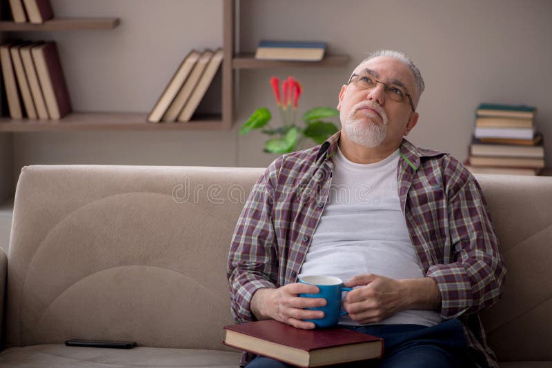 Old man sitting at home stock photo. Image of hours - 279636536