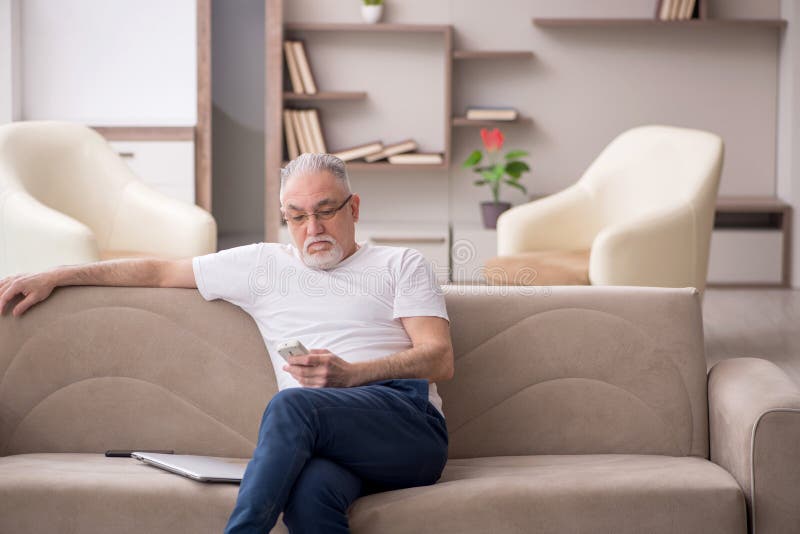 Old man sitting at home stock image. Image of channels - 276154111