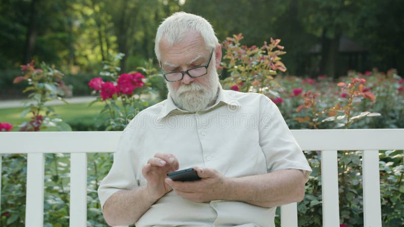 Old Man Using a Phone Outdoors Stock Photo - Image of hair, outside ...