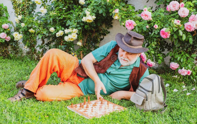 Old Man in Spring Rosesgarden with Chess. Hobby Concept. Happy Old Age ...