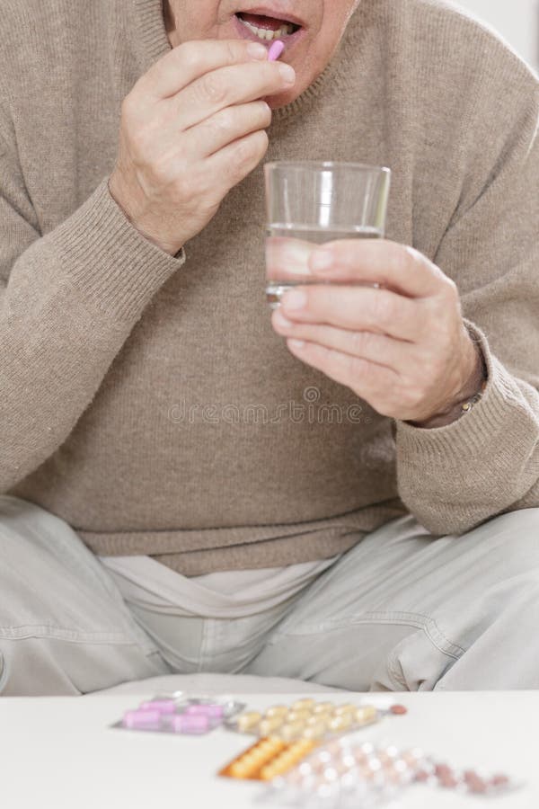 Old man taking tablet stock photo. Image of medication - 63079334