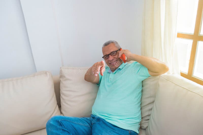 An Old Man Talking on His Cell Phone at Home Stock Photo - Image of ...