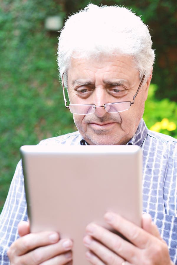 Old Man Using Digital Tablet. Stock Photo - Image of adult, portable ...