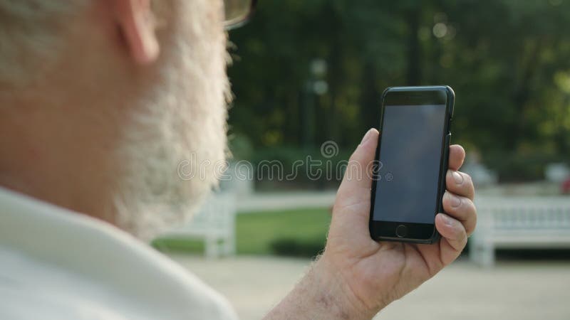 Old Man Using a Phone Outdoors Stock Image - Image of gray, passersby ...