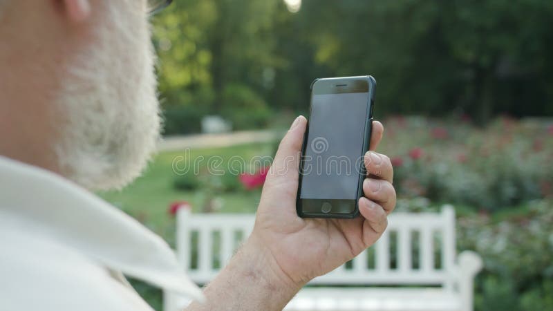 Old Man Using a Phone Outdoors Stock Image - Image of flowers ...