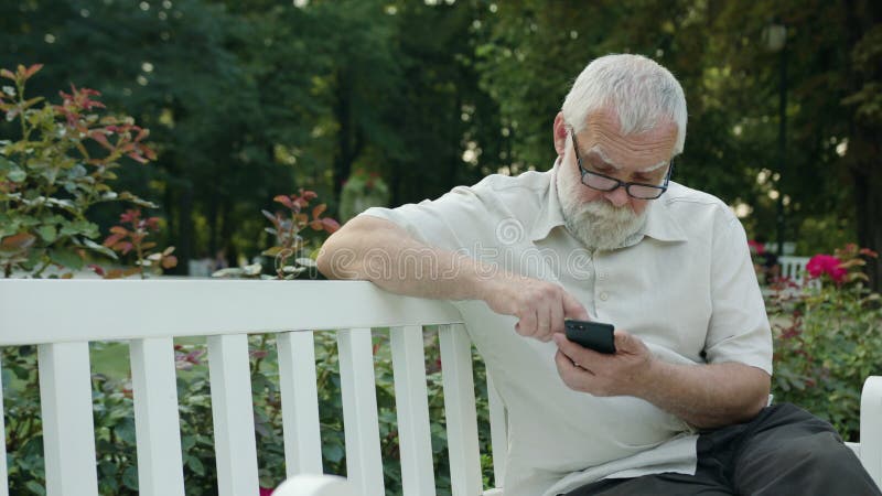 Old Man Using a Phone Outdoors Stock Photo - Image of hair, outside ...