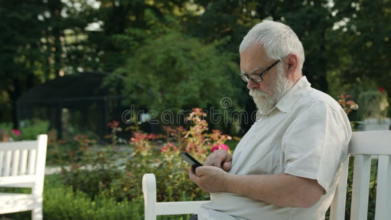 Old Man Using a Phone Outdoors Stock Photo - Image of online ...