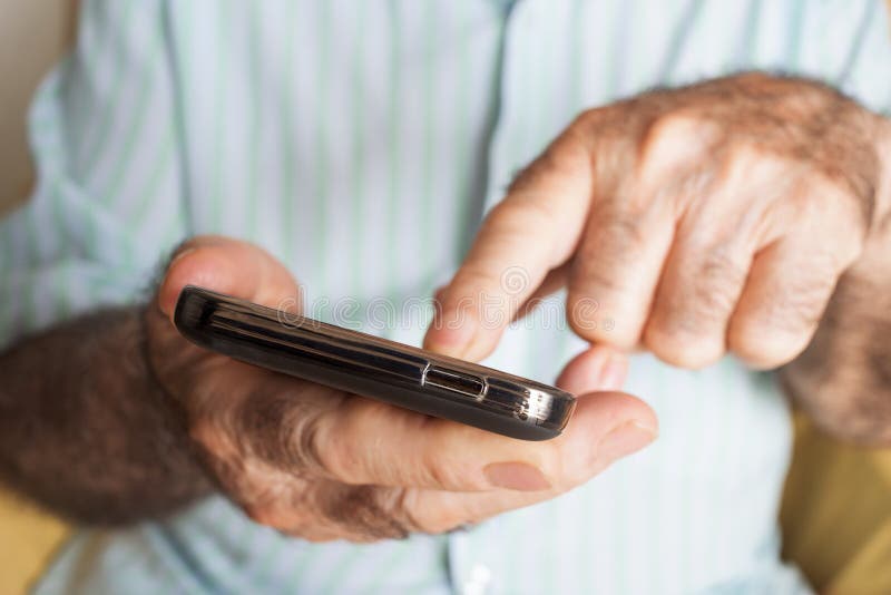 Old man using a smartphone stock photo. Image of electronic - 57625722