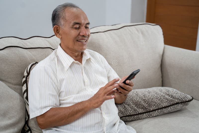 Old Man Using Smartphone at Home Stock Image - Image of relax, read ...