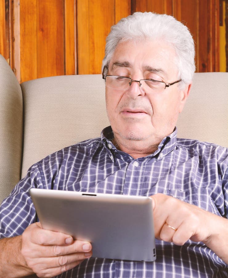 Old man using tablet. stock image. Image of home, holding - 97492837