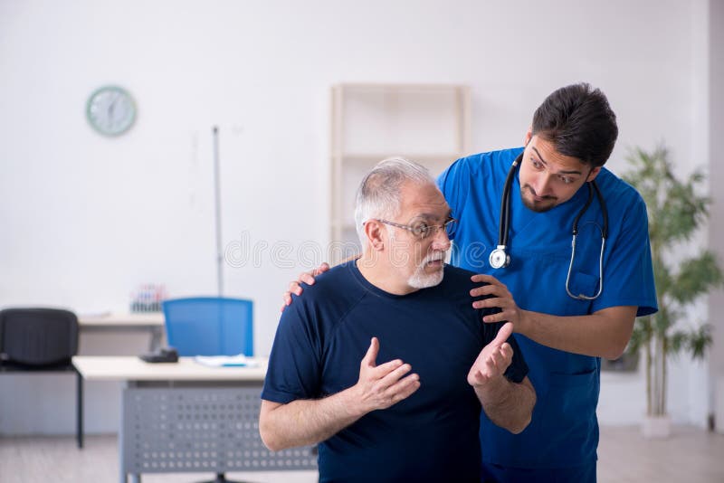 Old Man Visiting Young Male Doctor Stock Image - Image of clinic ...
