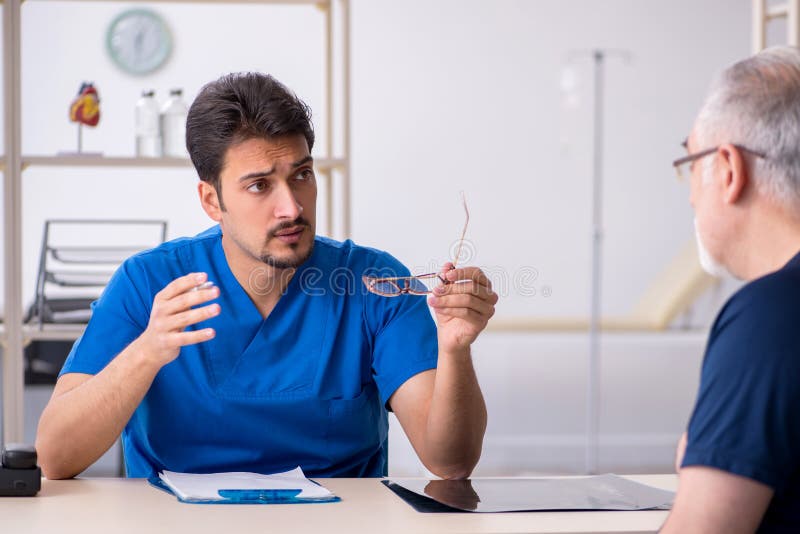 Old Man Visiting Young Male Doctor Stock Image - Image of patient ...