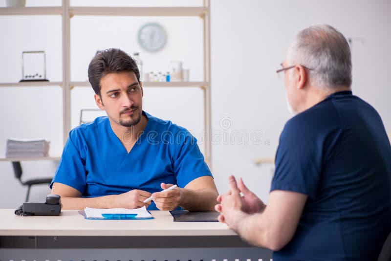 Old Man Visiting Young Male Doctor Stock Photo - Image of hospital ...