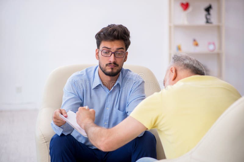 Old Man Visiting Young Male Psychotherapist Stock Photo - Image of ...