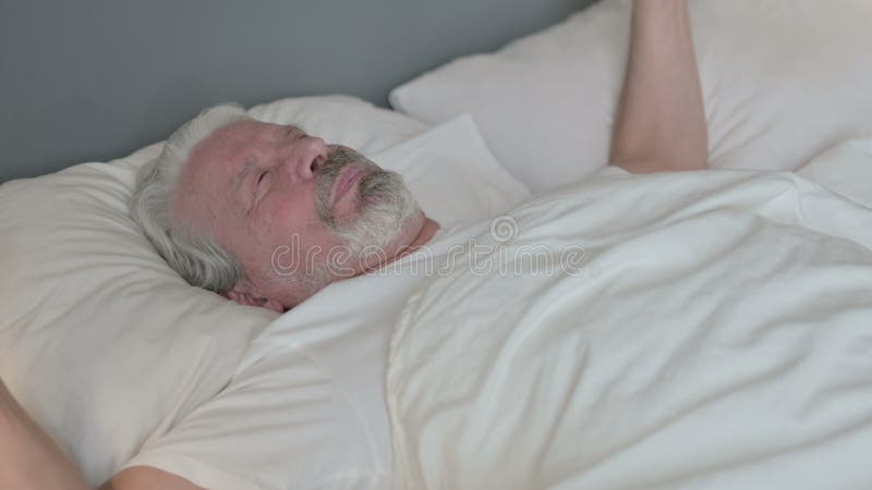 Old Man Waking Up from Sleep in Bed Stock Footage - Video of tired ...