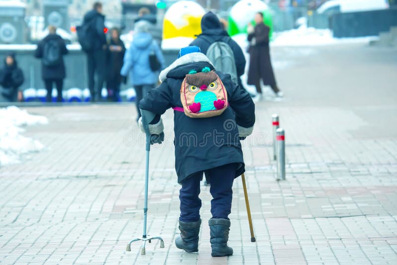 Old Man with Walking Sticks Walks on a City Street Stock Image - Image ...