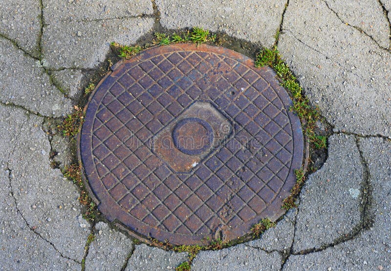 Old manhole on asphalt stock photo. Image of construction - 133811556
