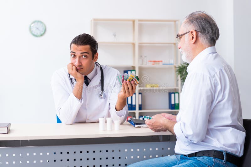 Old Man Visiting Young Male Doctor Stock Photo - Image of care, checkup ...
