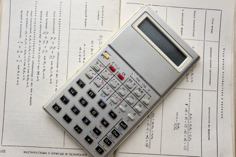 An Old Metal Calculator on the Math Reference Book Stock Photo - Image ...