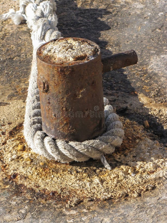 Metal Cleat for Mooring Boats, Bolted To the Ground, with Rope and ...