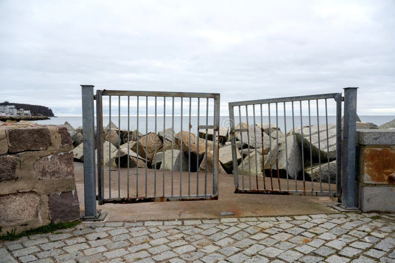 Old Metal Gate at a Breakwater in Front of the Sea Stock Photo - Image ...