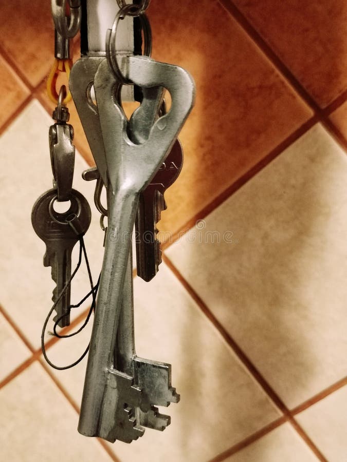 Old Metal Hanging Keys on a Background of Kitchen Orange Tiles Stock ...