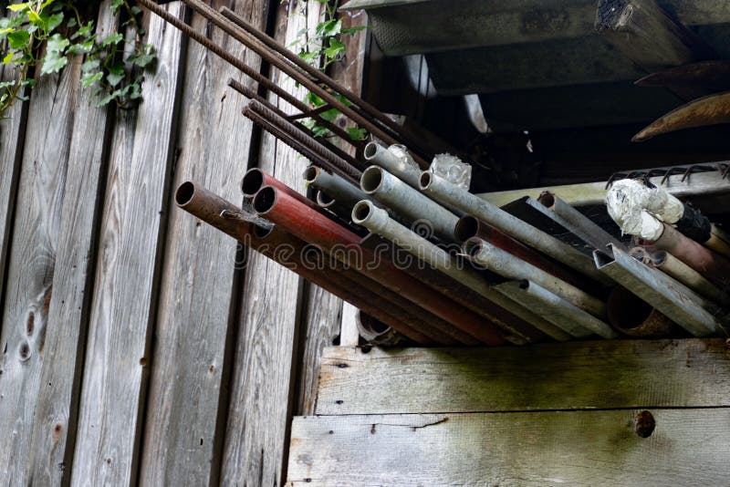 Old Metal Pipes and Rods Hanging Out of a Barn Stock Photo - Image of ...