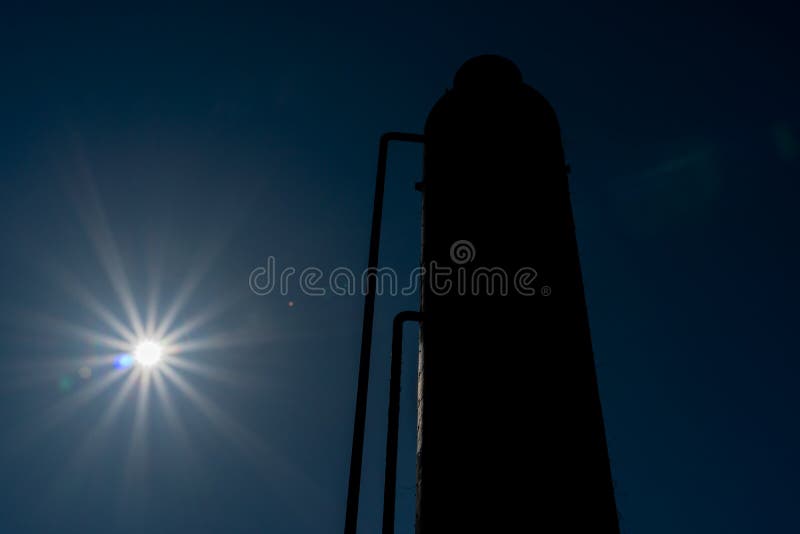 An Old Metal Rusty Water Tower Against the Background of the Blue Sky ...