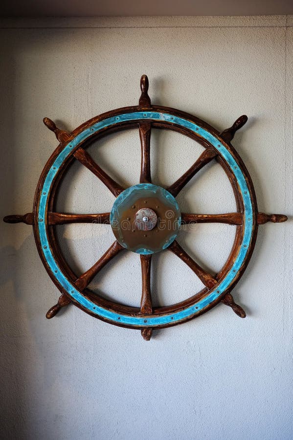 Old Metal Ship Steering Wheel Decoration on Concrete Wall. Stock Image ...