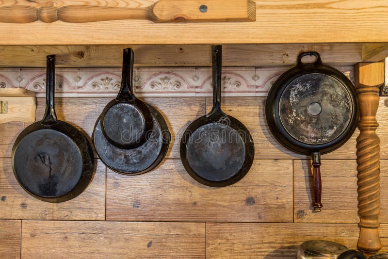Old Metallic Rustic Pans Hanging on the Wooden Wall Stock Photo - Image ...