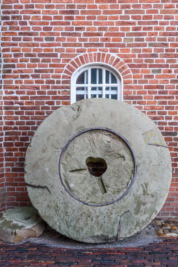 Old Millstone Standing in Front of a Windmill in East Frisia Stock ...