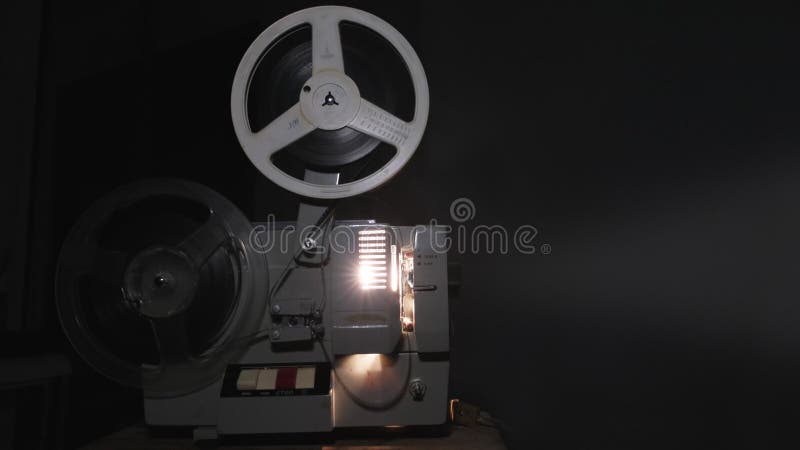 Old projector showing film stock footage. Video of light - 347165024