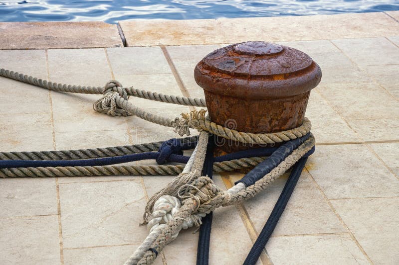 Old Mooring Bollard with Ropes on Wharf Stock Photo - Image of port ...