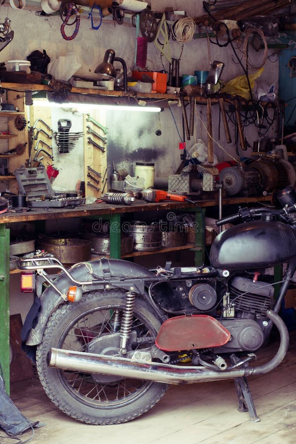 Old Motorcycle, Equipment and Tools on the Desktop in the Garage Stock ...