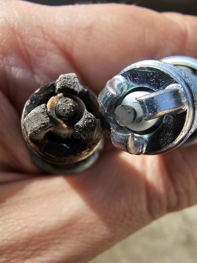 Old and New Spark Plugs Ends in a Hand Stock Photo - Image of parts ...