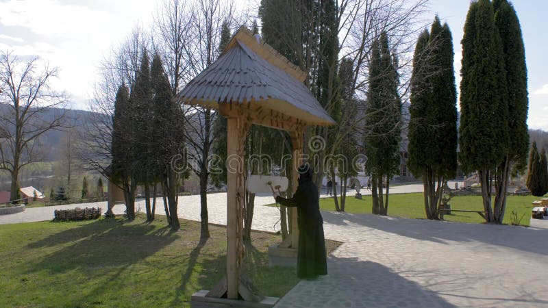 Old Nun at Monastery Calling the People Beating the Wood Stock Footage ...