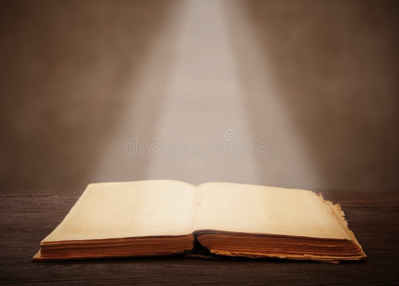 Old Open Book on a Wooden Table Light Beam Illuminates the Page Stock ...