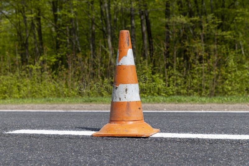 An Old Orange Cone on an Asphalt Road during Marking Stock Image ...