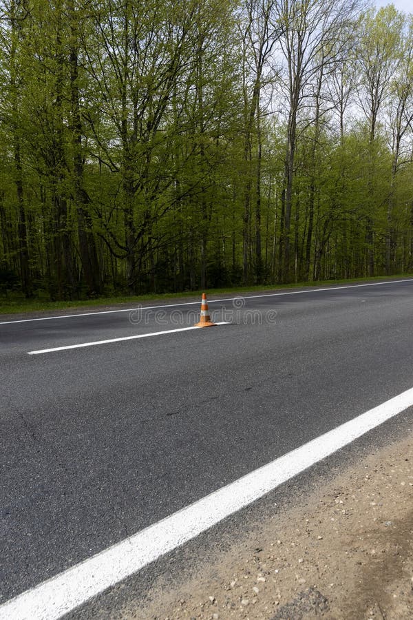 An Old Orange Cone on an Asphalt Road during Marking Stock Image ...