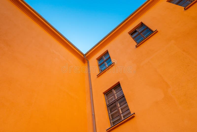 Old Orange Industrial Building Under Blue Sky Stock Photo - Image of ...